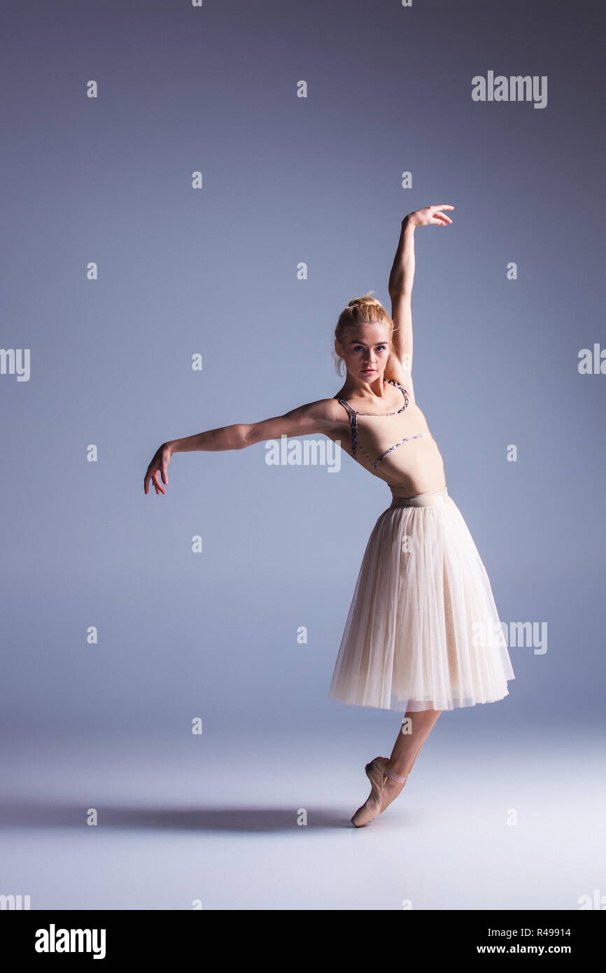 Young beautiful modern style dancer posing on a studio background Stock ...