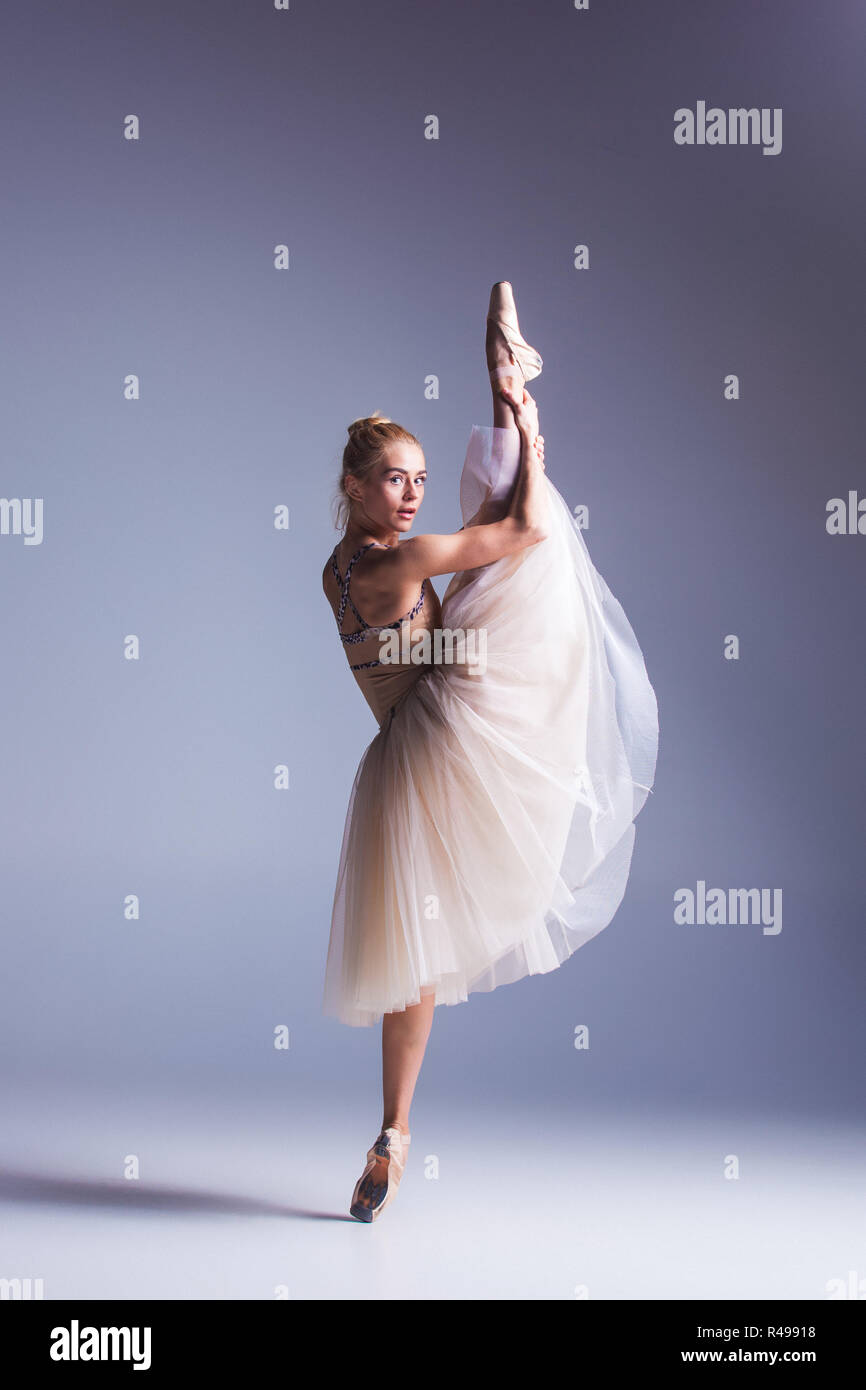 Young beautiful modern style dancer posing on a studio background Stock ...
