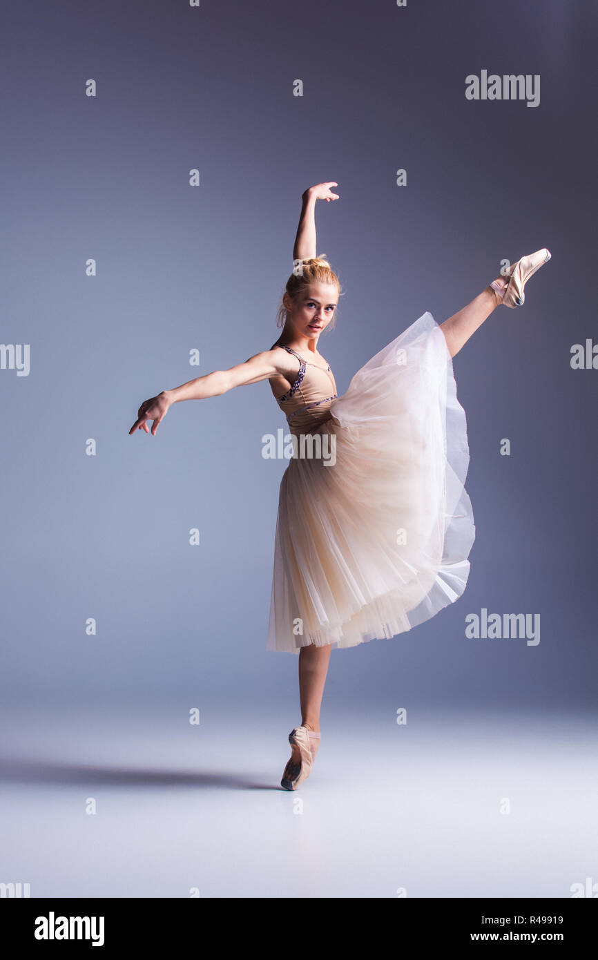 Young beautiful modern style dancer posing on a studio background Stock ...
