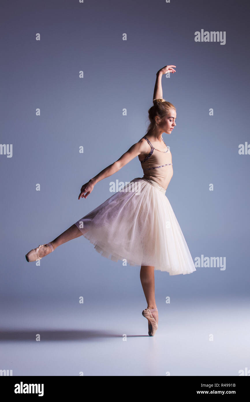 Young beautiful modern style dancer posing on a studio background Stock ...