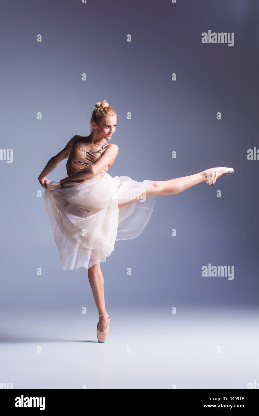 Young beautiful modern style dancer posing on a studio background Stock ...