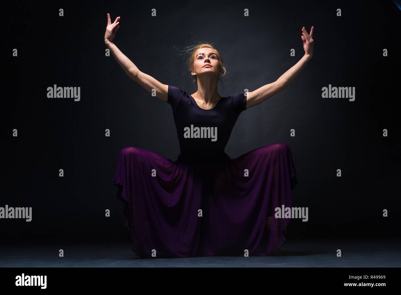 Young beautiful modern style dancer posing on a studio background Stock ...