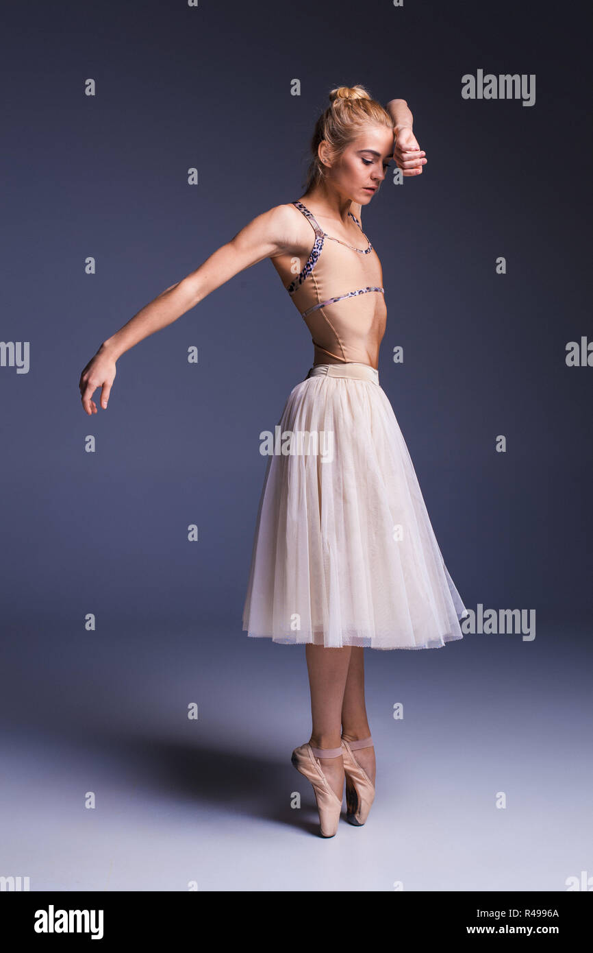 Young beautiful ballerina dancer dancing on a studio background Stock ...