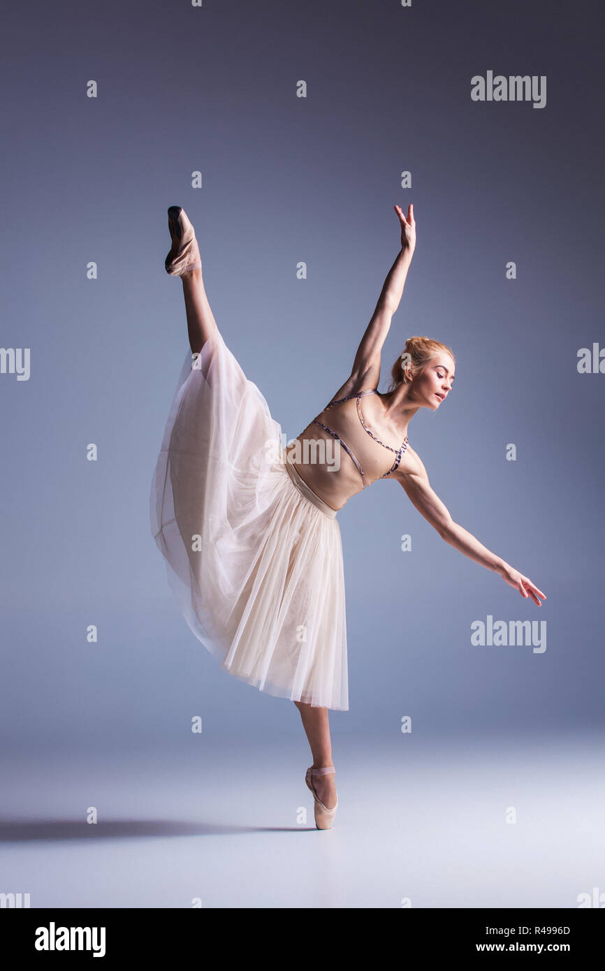 Young beautiful ballerina dancer dancing on a studio background Stock ...