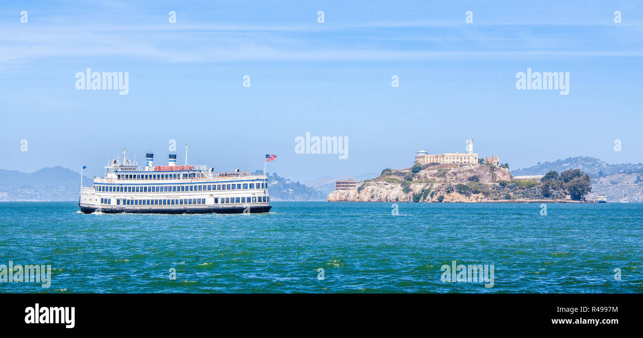 Famous Alcatraz Island with traditional historic excursion boat on a ...