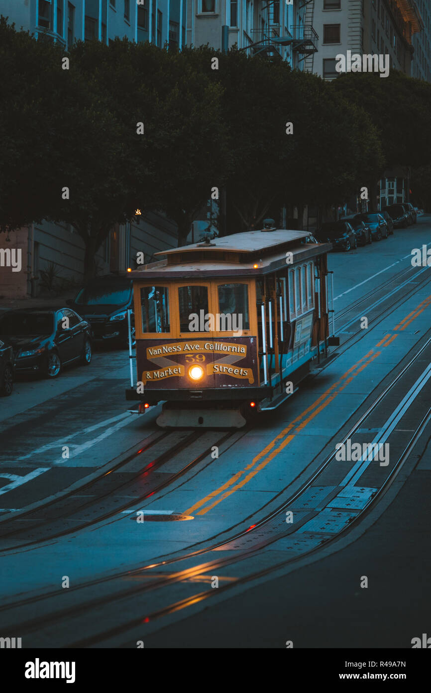 Magical twilight view of historic Cable Car riding on famous California ...