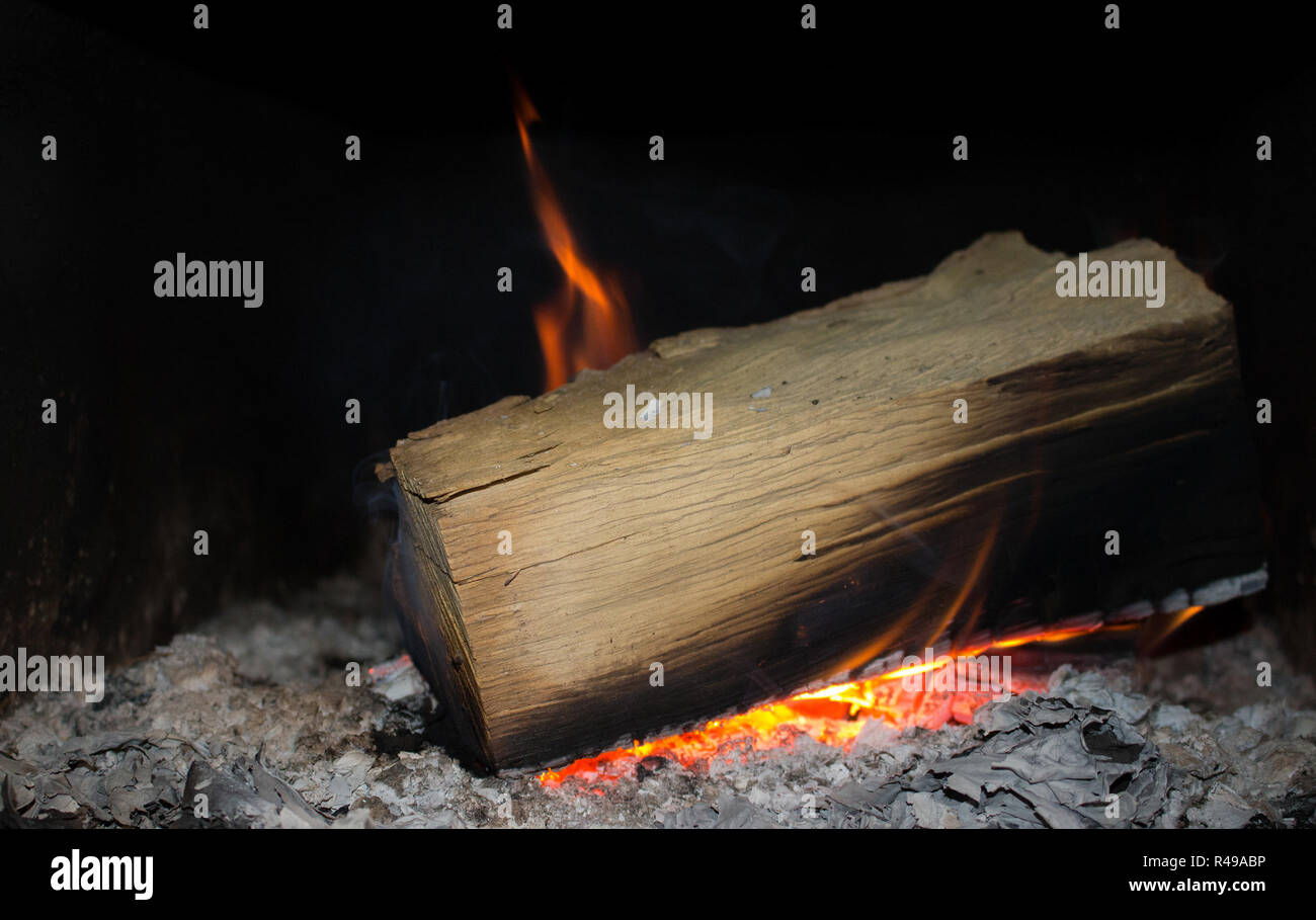 Burning wood with gray coals on black background Stock Photo - Alamy