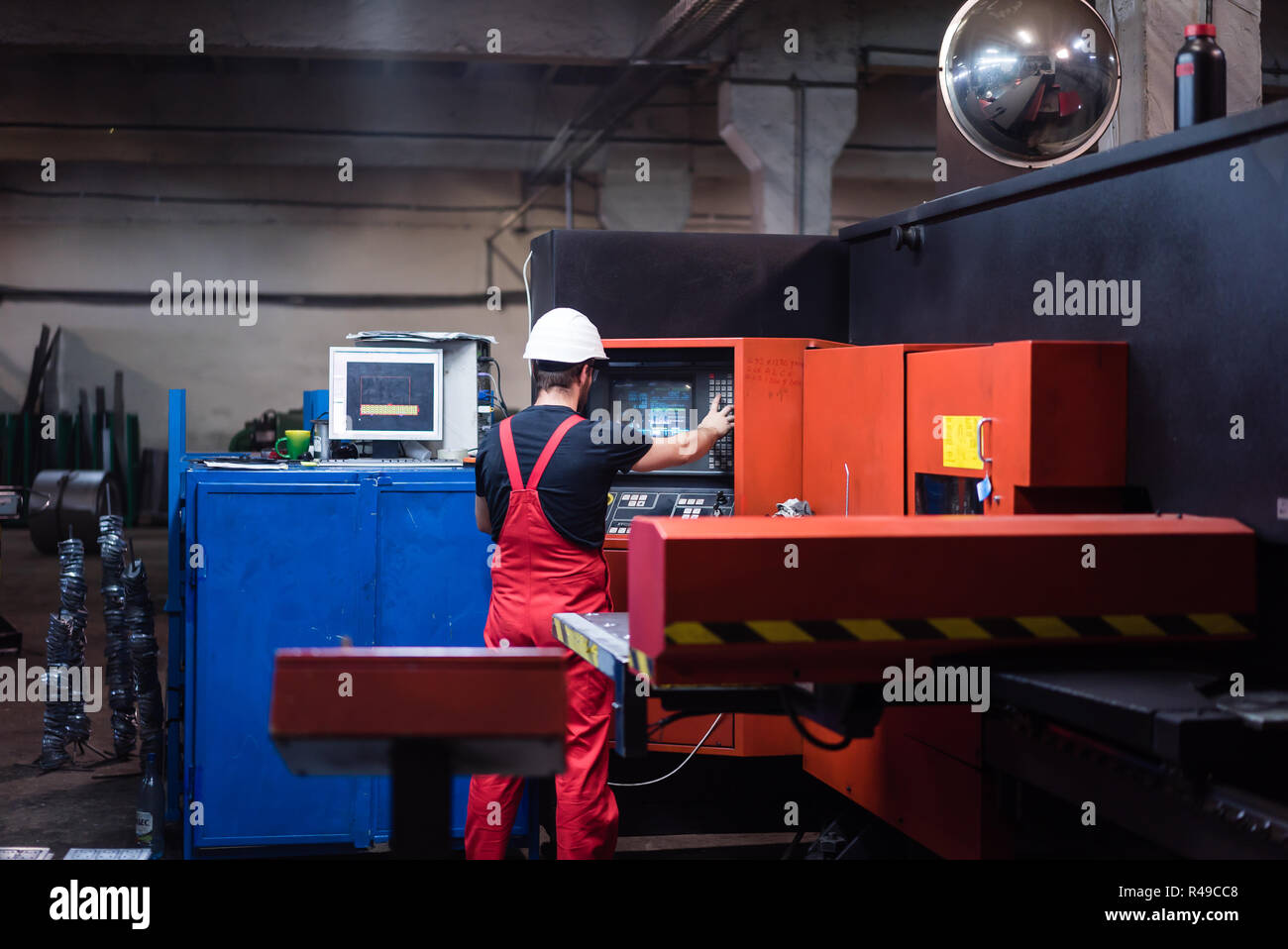 operating a red-painted heavy-duty machinery Stock Photo - Alamy