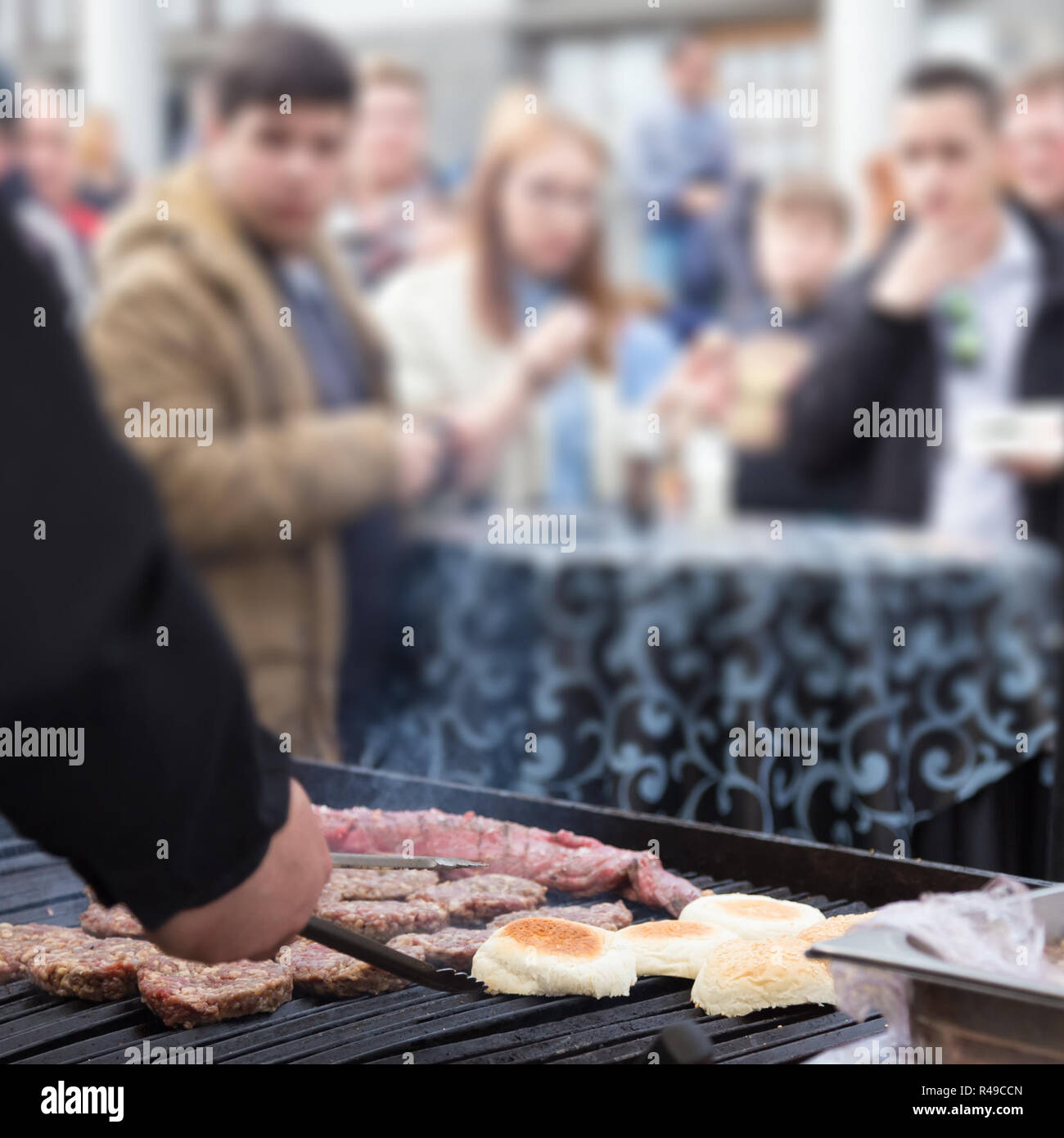Beef burgers being grilled on food stall grill Stock Photo - Alamy