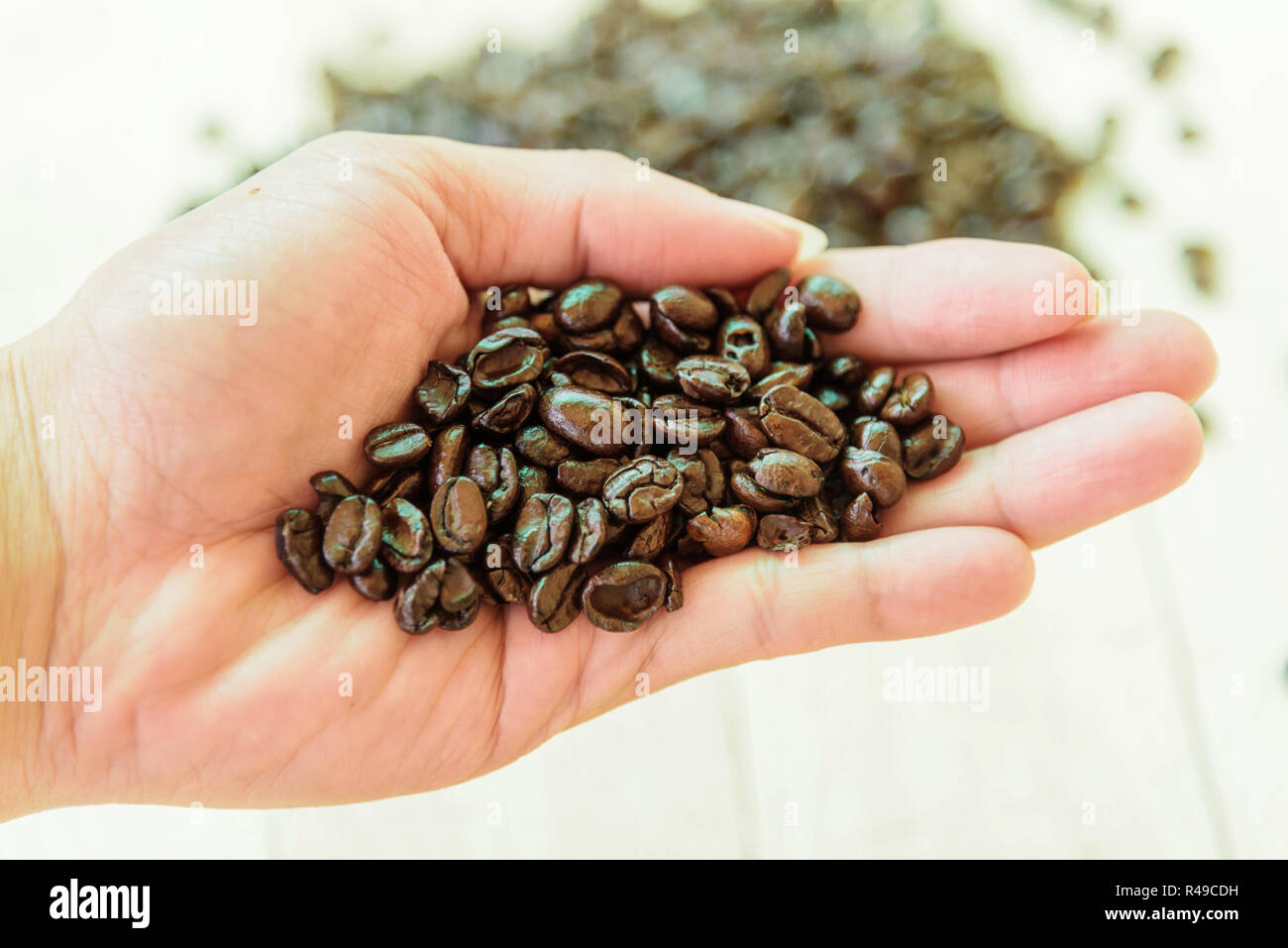 Coffee beans in the hand Stock Photo - Alamy
