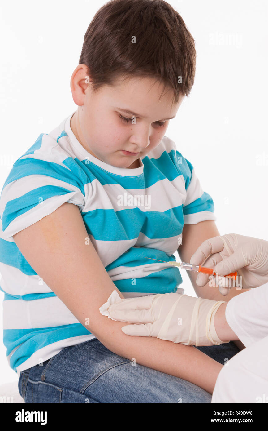 Doctor giving a child injection in arm on isolated image Stock Photo ...