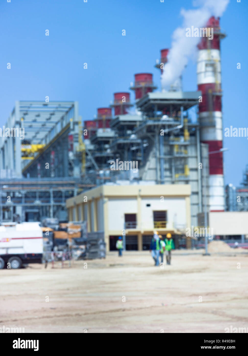 Blurred industrial background image of a power plant exterior on a ...