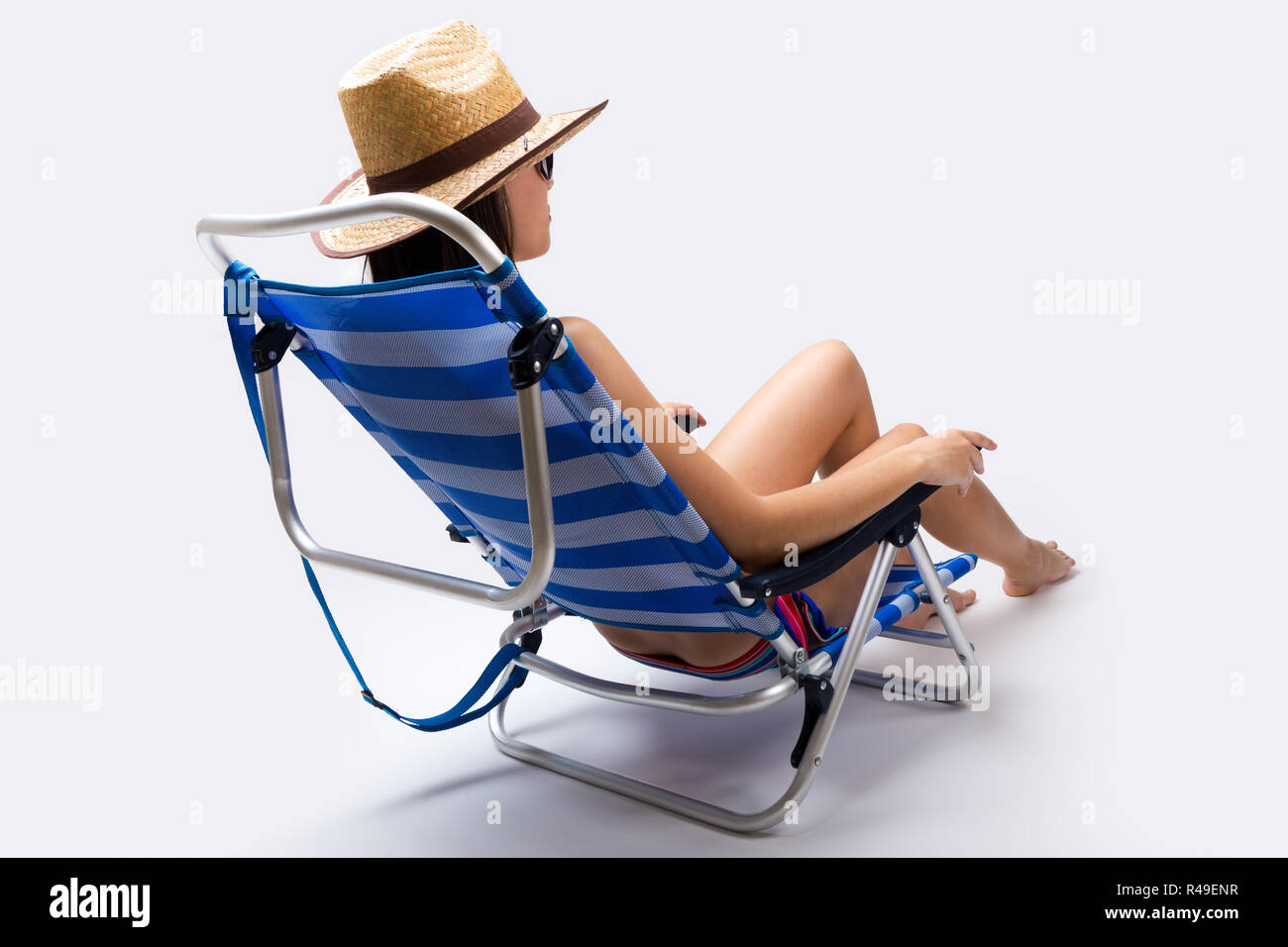 beautiful young woman with bikini sitting on a beach chair Stock Photo ...