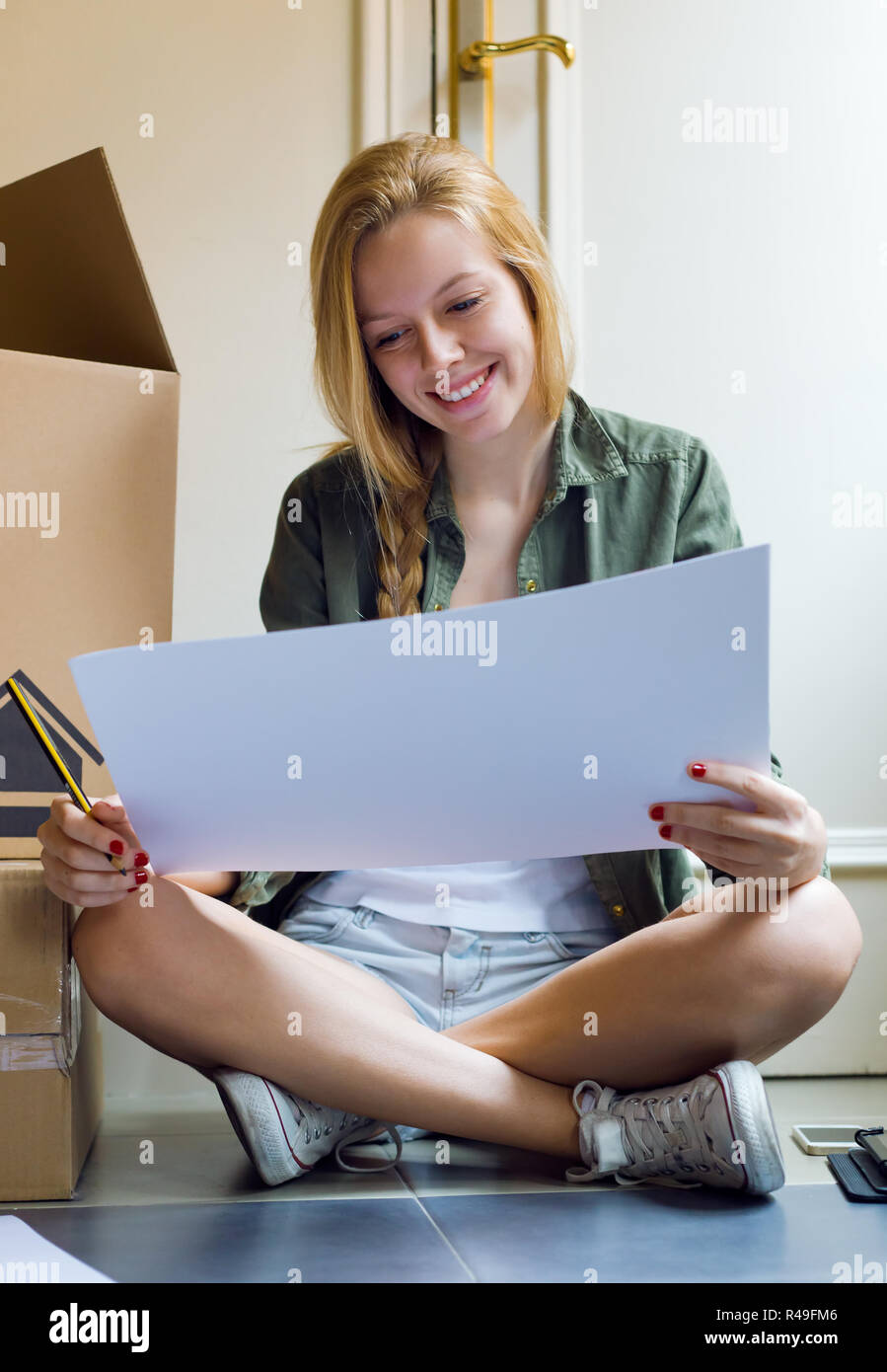 Young beautiful woman moving in new home Stock Photo - Alamy