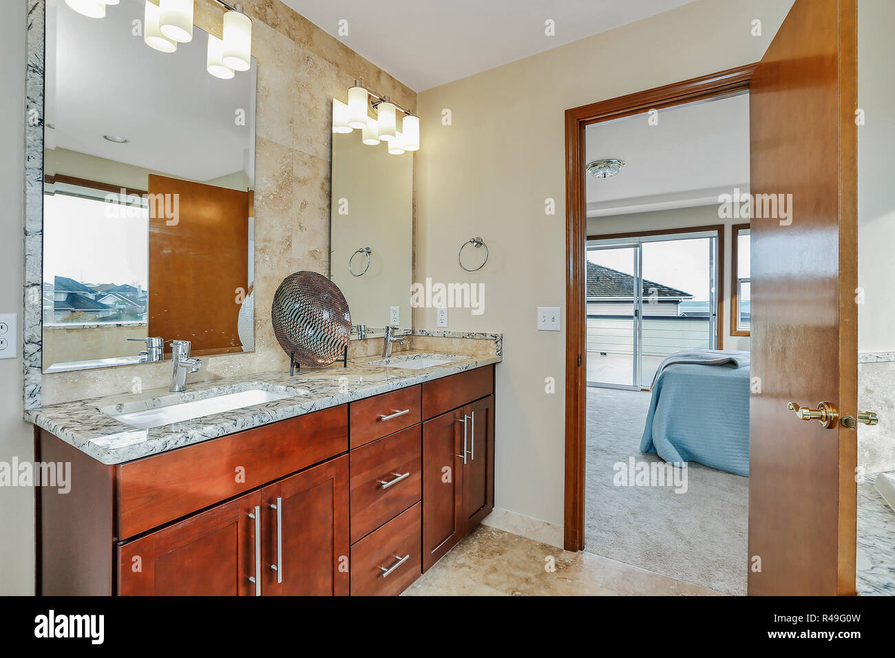 Bathroom with large mirror and granite counter top Stock Photo - Alamy