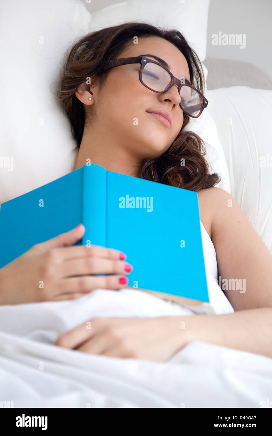 Beautiful young woman sleeping after read a book Stock Photo - Alamy