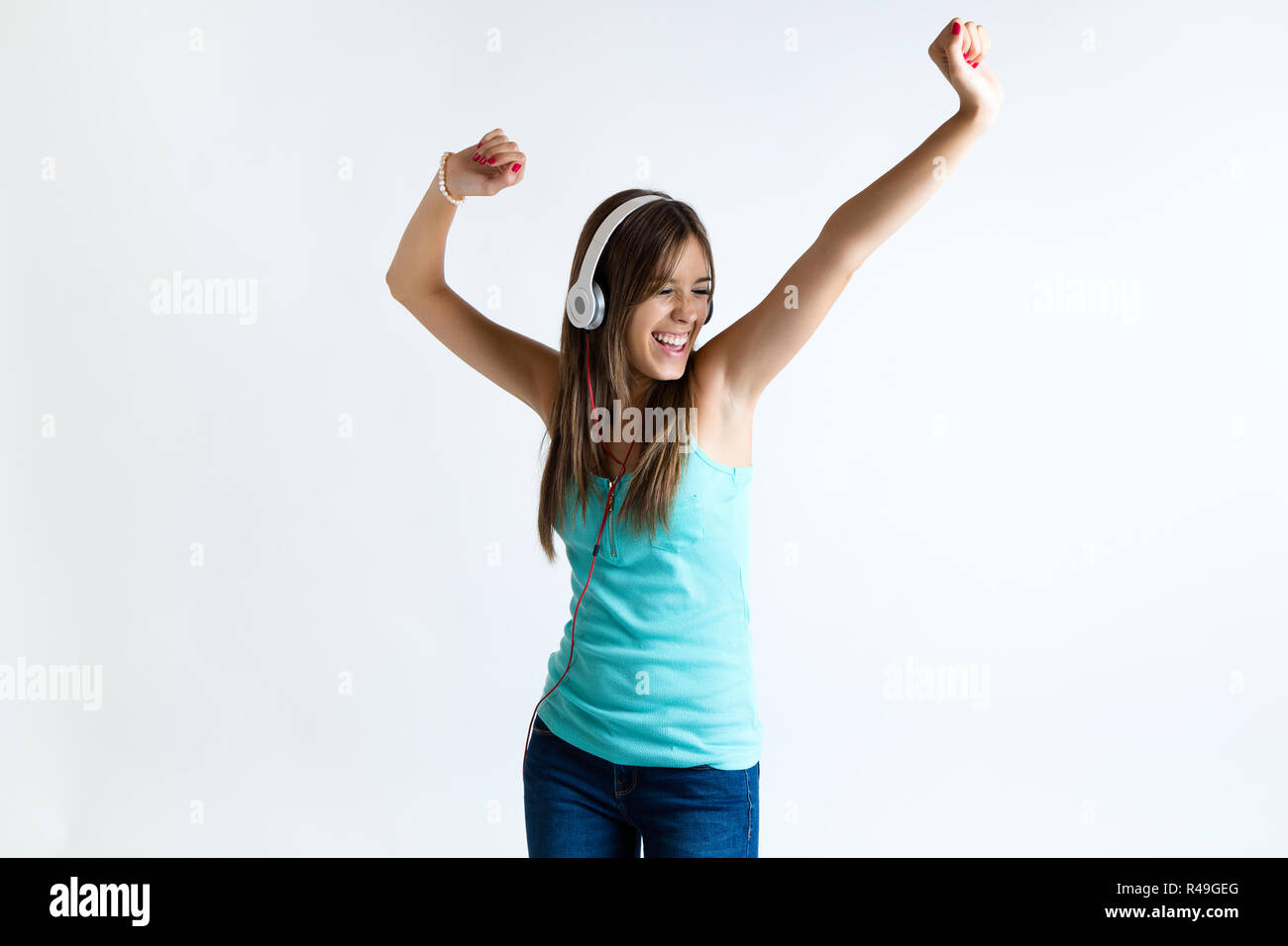 Beautiful girl dancing and listening to music. Isolated on white Stock ...