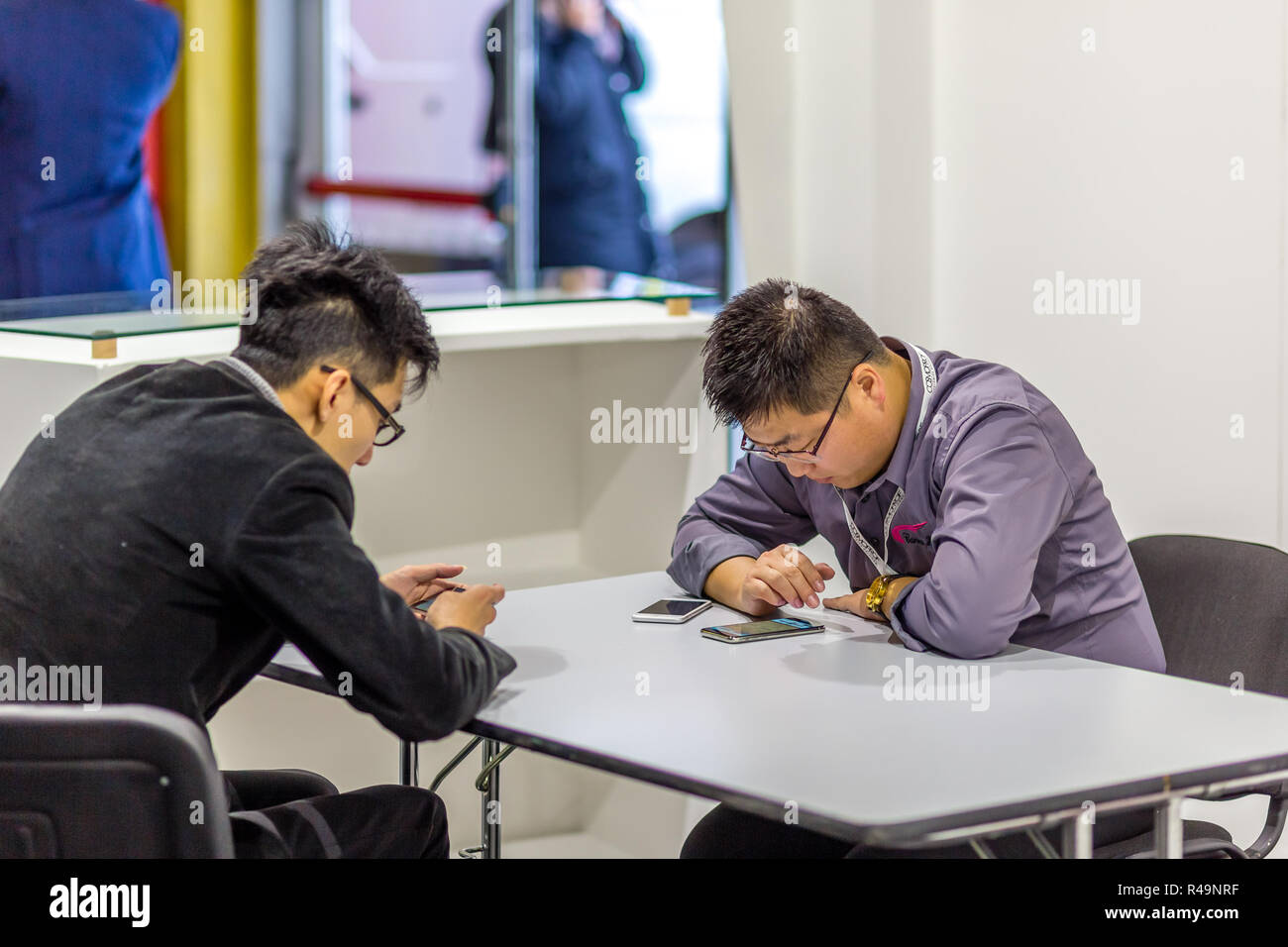 Bologna, Italy. 25th November, 2018. Asian booth presenters using ...