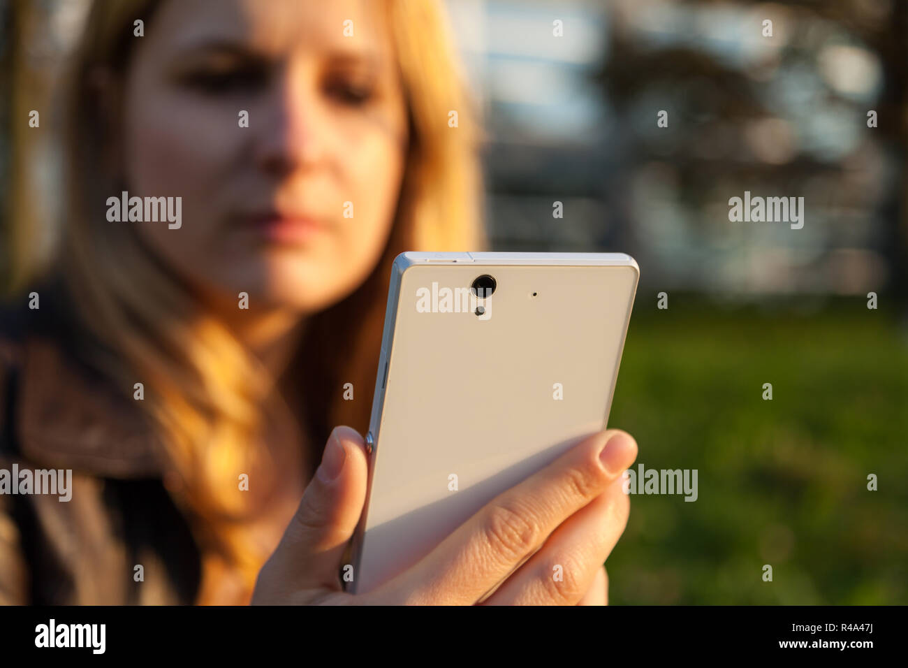 woman with apathetically face and smartphone Stock Photo - Alamy