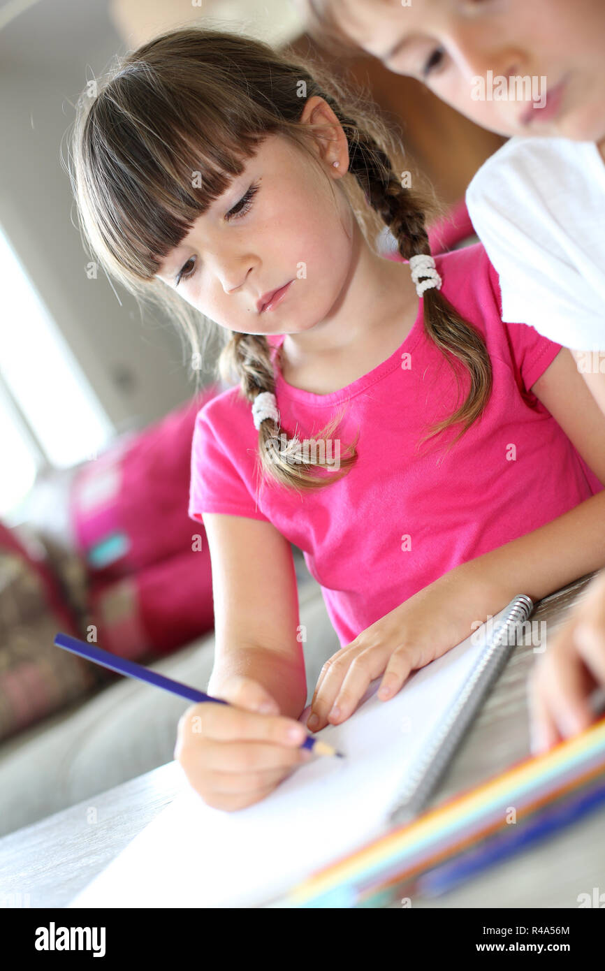 Portrait of kids at home drawing with pencils Stock Photo - Alamy