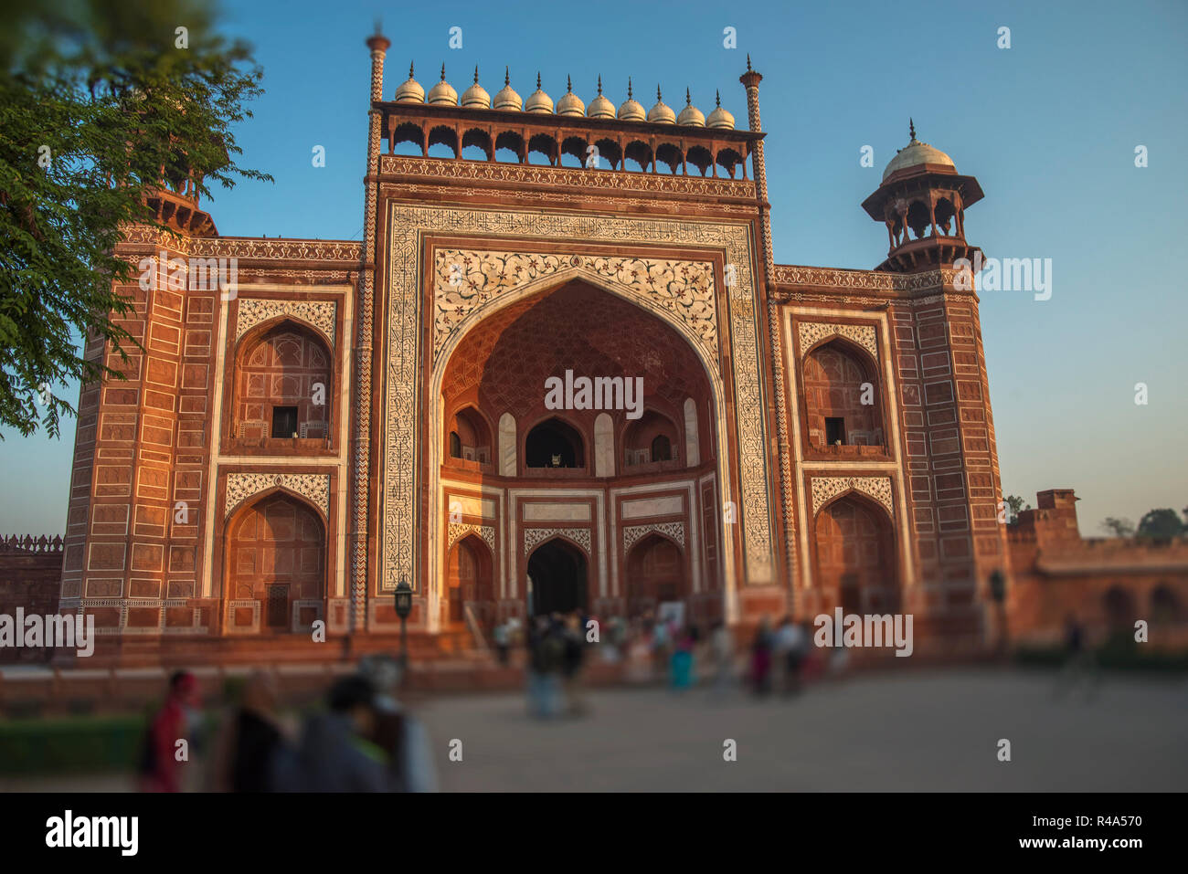 gate through which the Taj Mahal visitors in a park that surrounds the ...