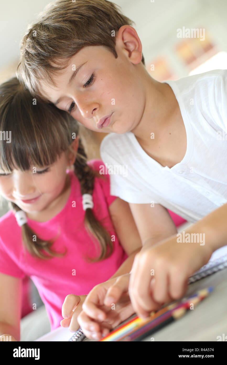 Portrait of kids at home drawing with pencils Stock Photo - Alamy