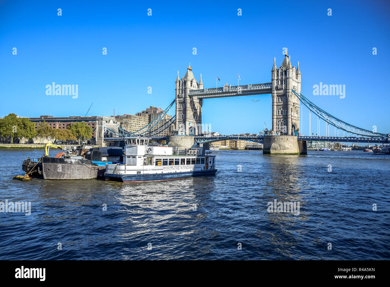 Tower Bridge, famous iconic symbol of London, crosses the River Thames ...