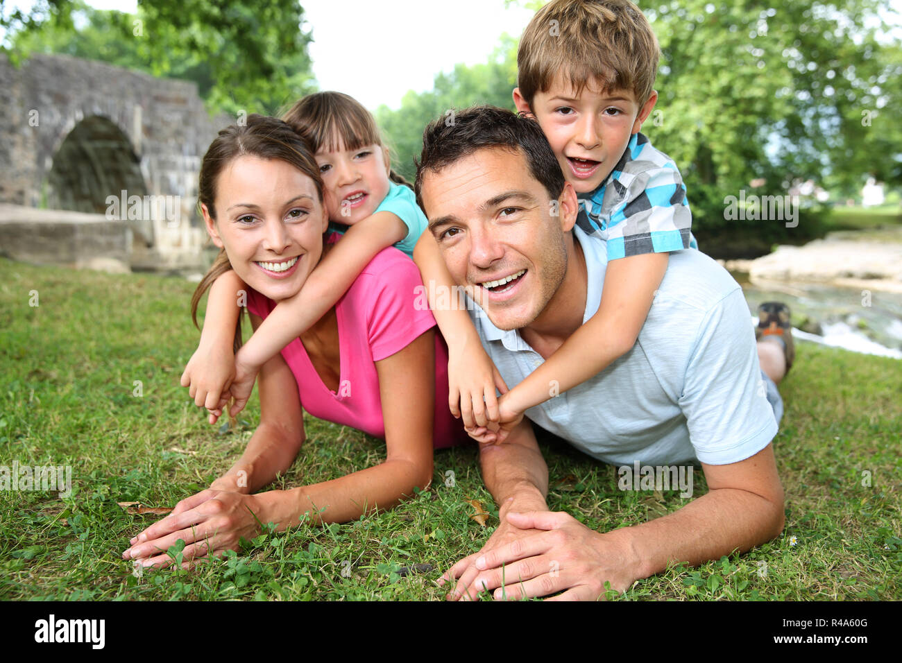 Portrait of parents with kids on their back Stock Photo - Alamy