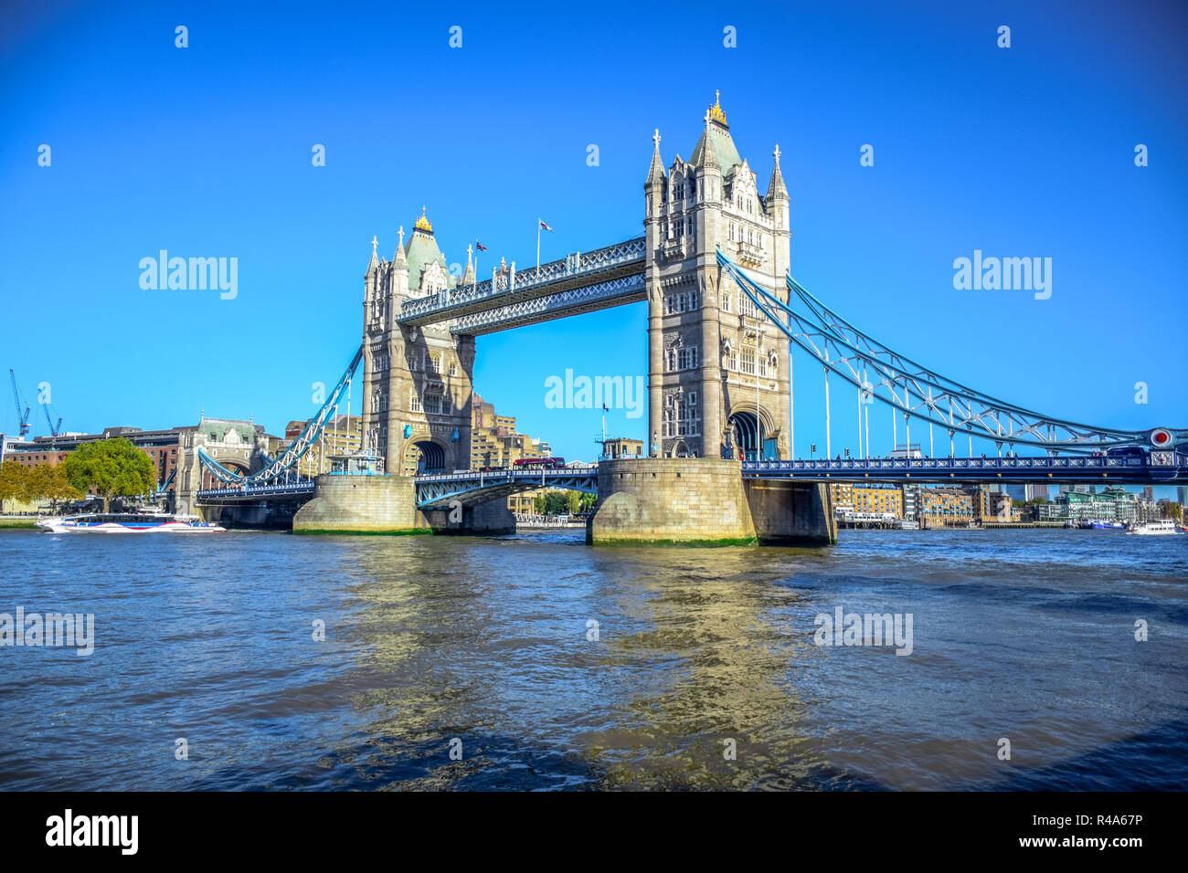 Tower Bridge, famous iconic symbol of London, crosses the River Thames ...