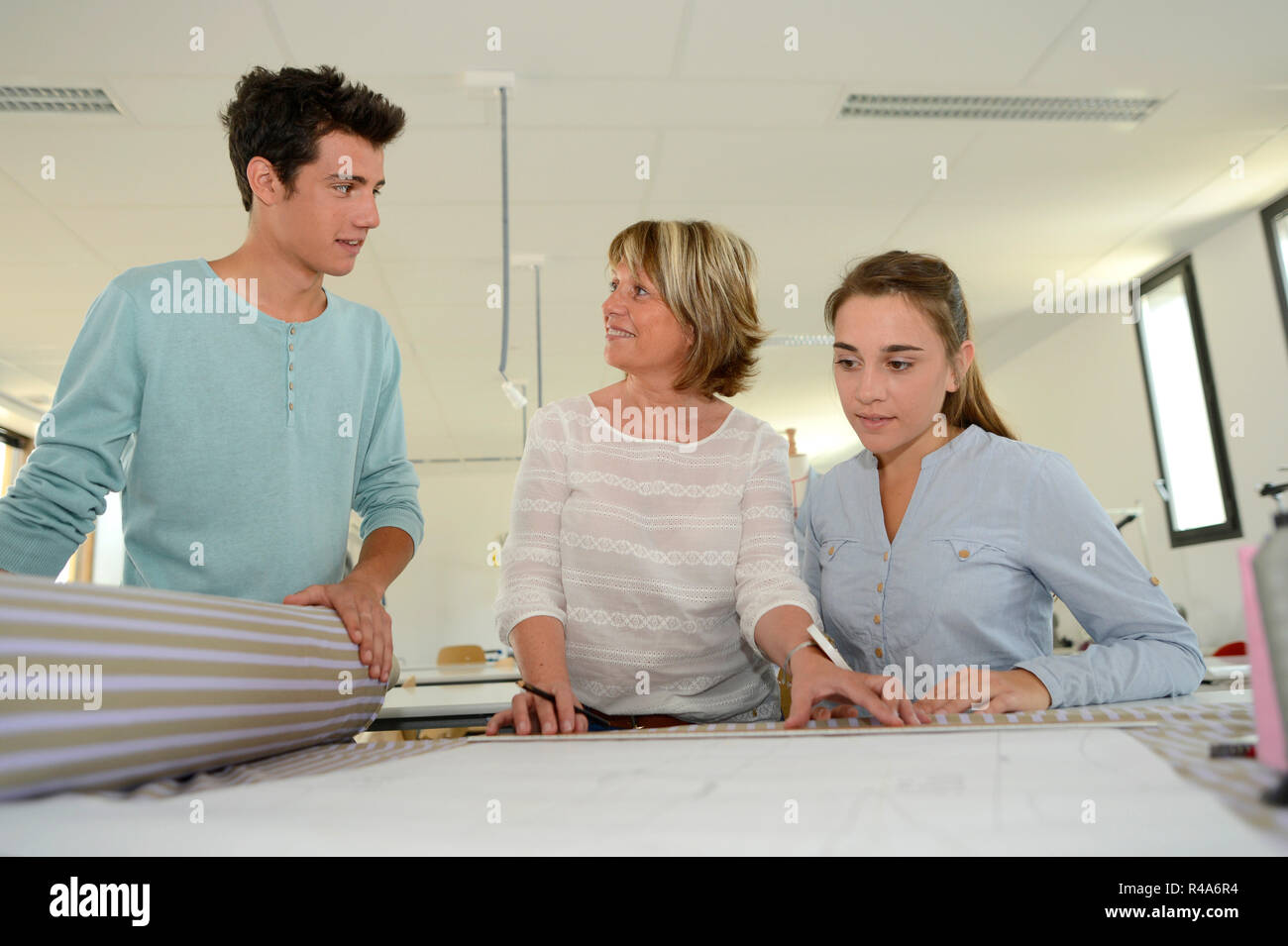Group of students in dressmaking training school Stock Photo - Alamy