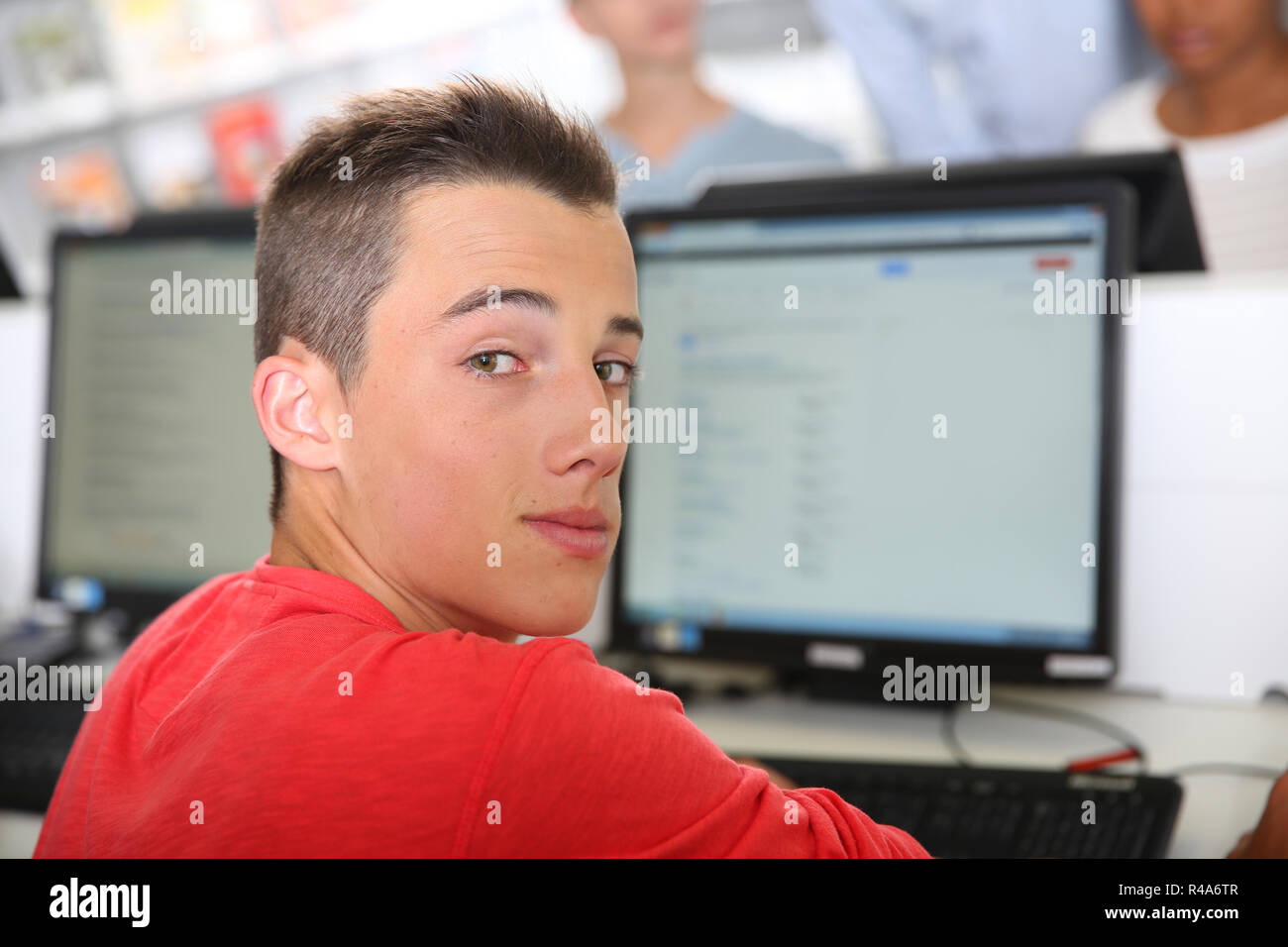 High-shool boy sitting in front of desktop computer Stock Photo - Alamy