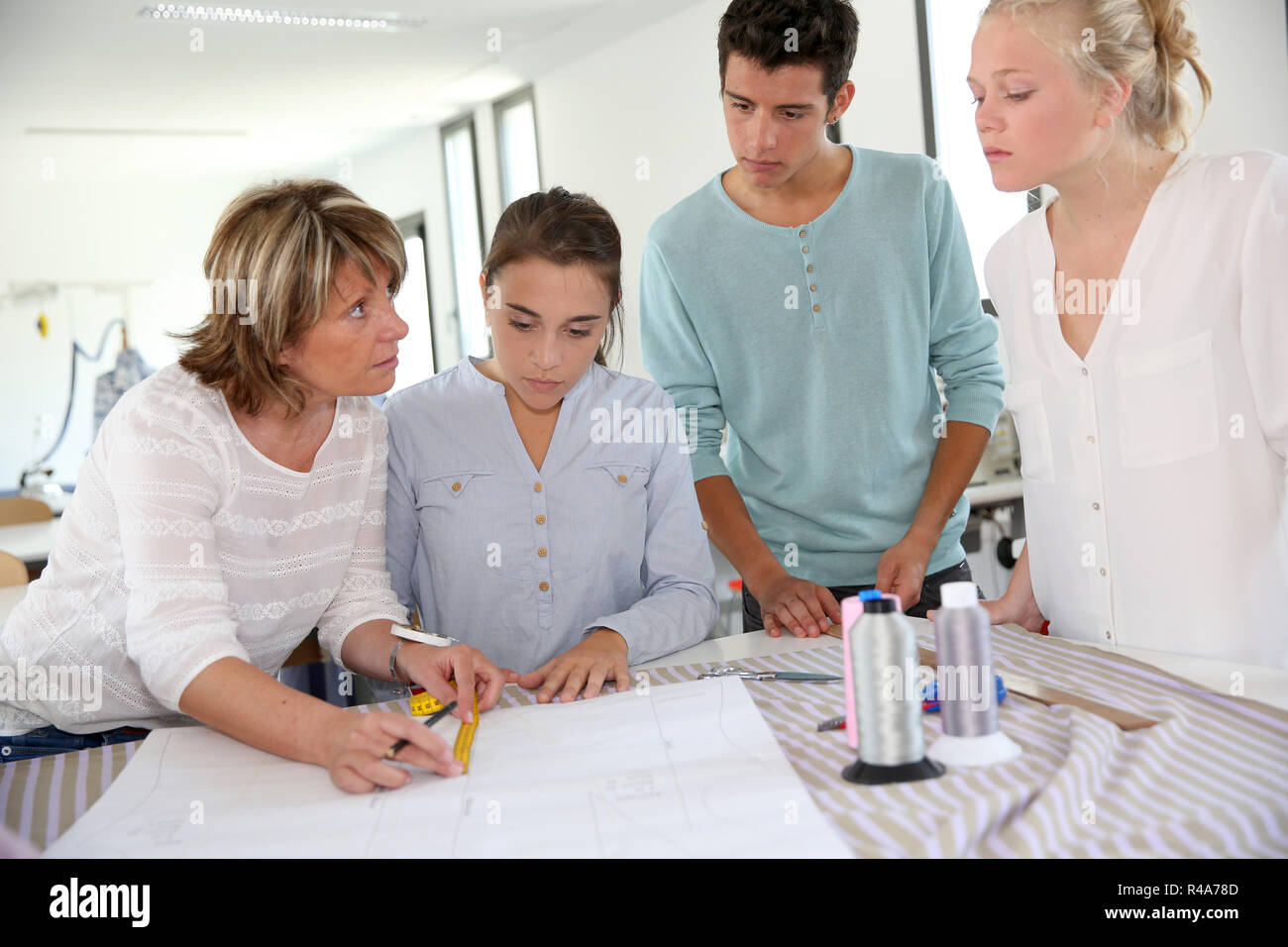 Group of students in dressmaking training school Stock Photo - Alamy