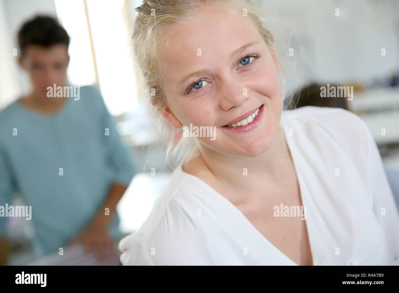 Portrait of smiling student girl in sewing class Stock Photo - Alamy