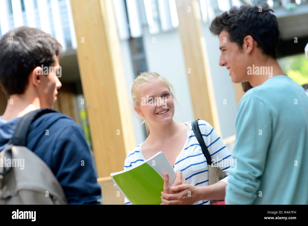 Cheerful students standing outside school building Stock Photo - Alamy