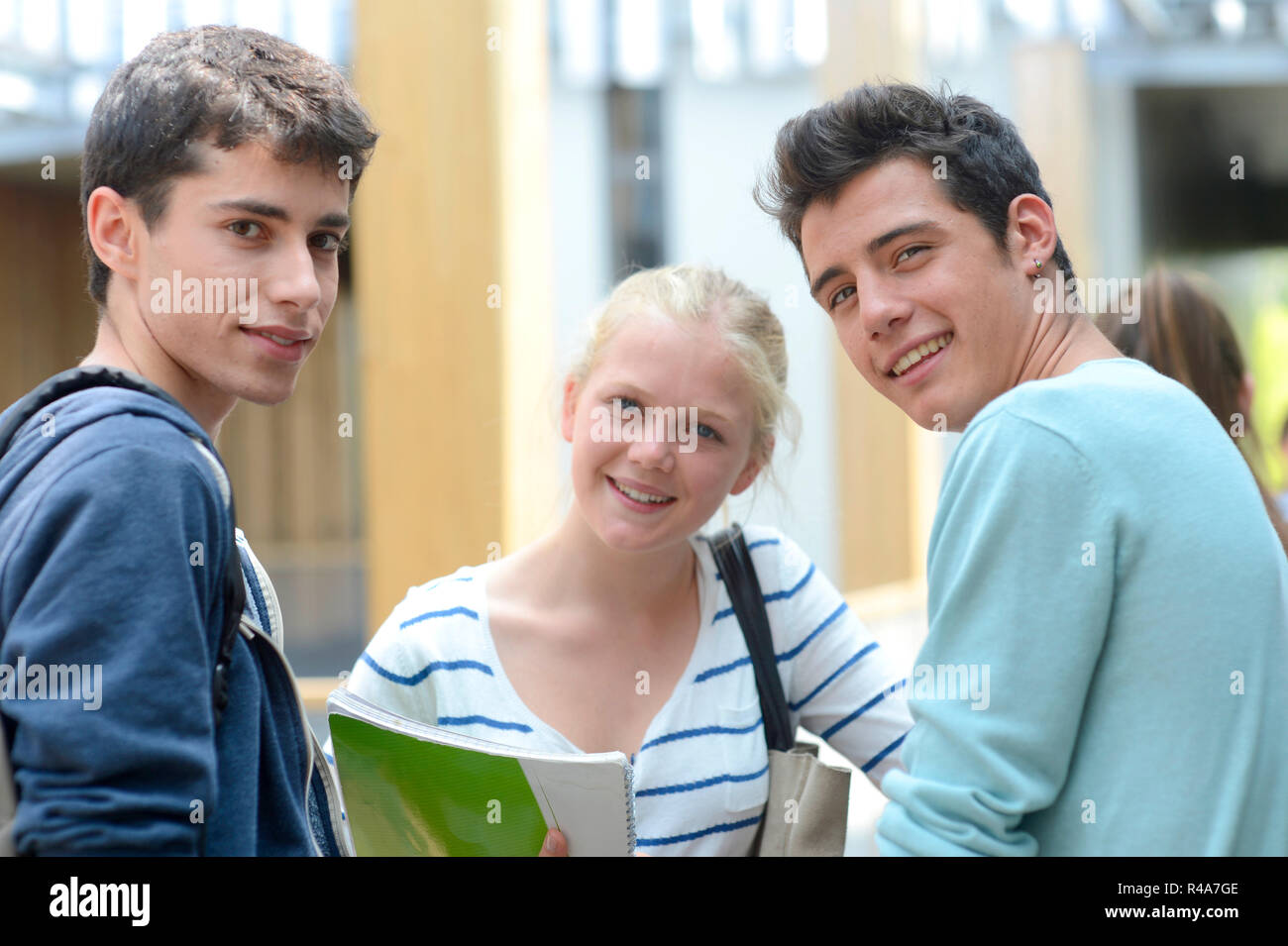 Cheerful students standing outside school building Stock Photo - Alamy