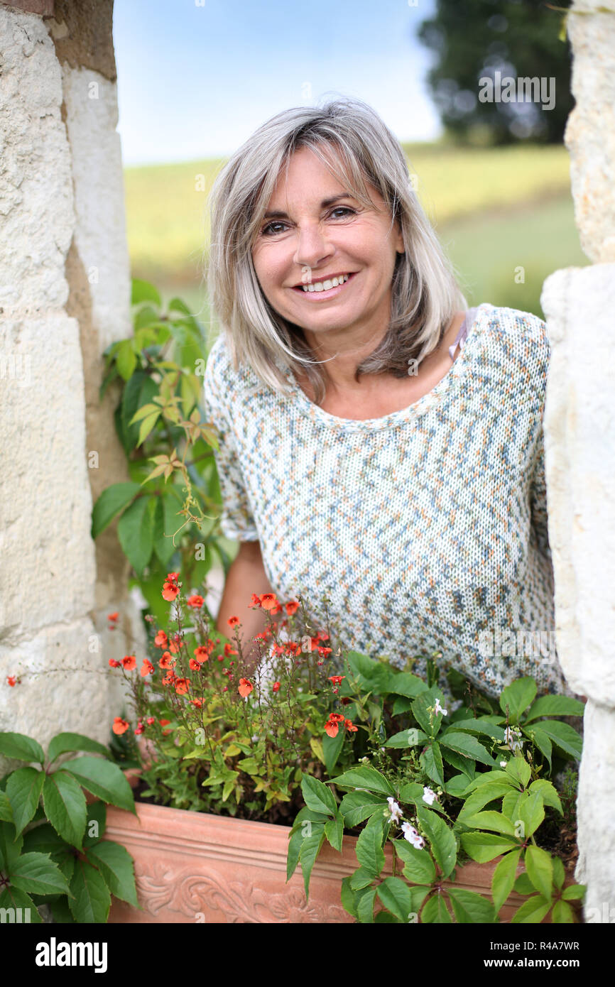 Portrait of serene mature woman in garden Stock Photo - Alamy