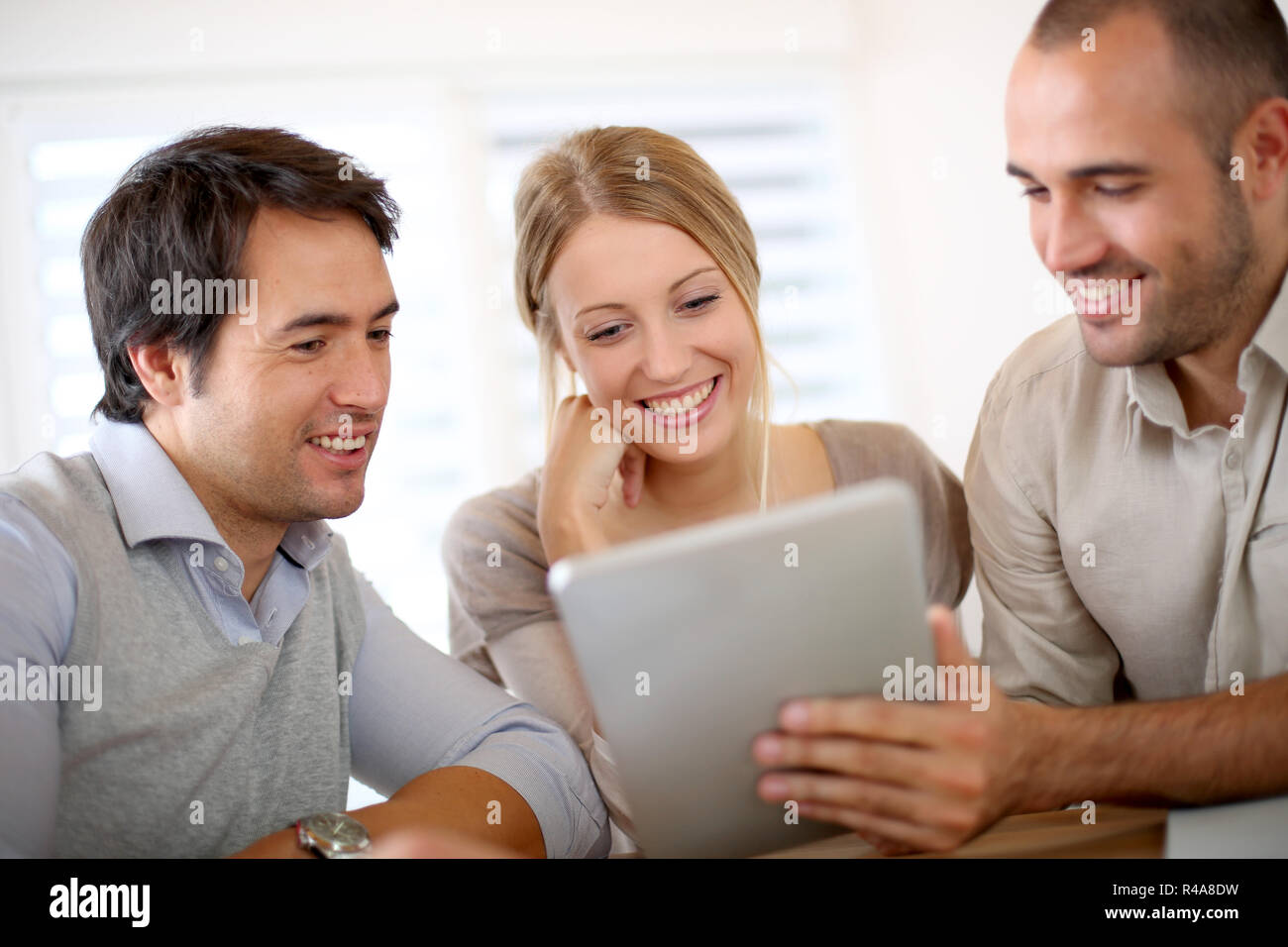 Business team in office working on tablet Stock Photo - Alamy