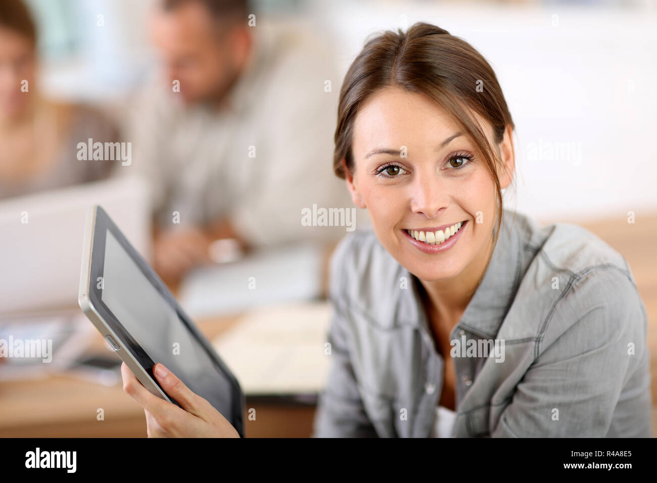 Young woman using tablet in business training Stock Photo - Alamy