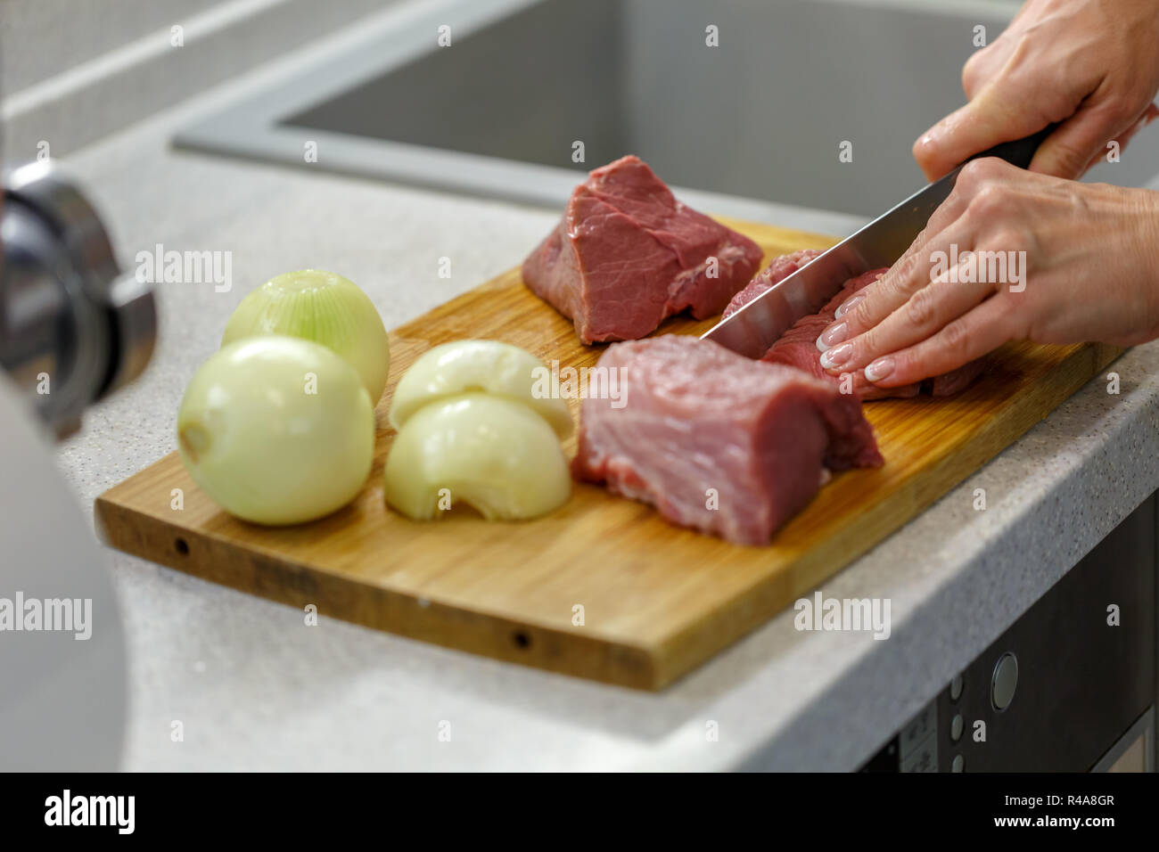 Woman cuts meat pieces hi-res stock photography and images - Alamy