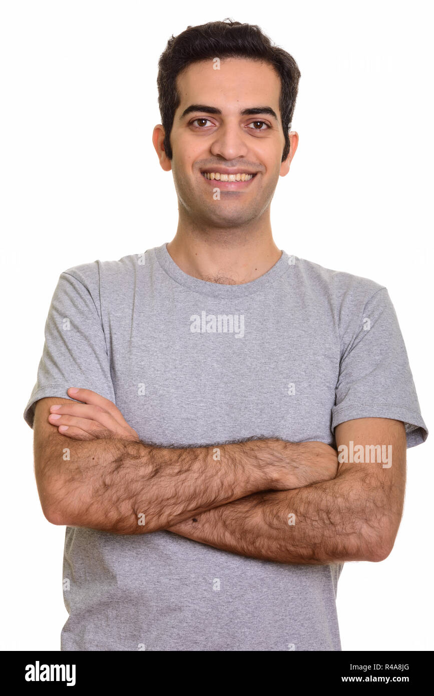 Portrait of young happy Persian man smiling with arms crossed Stock ...