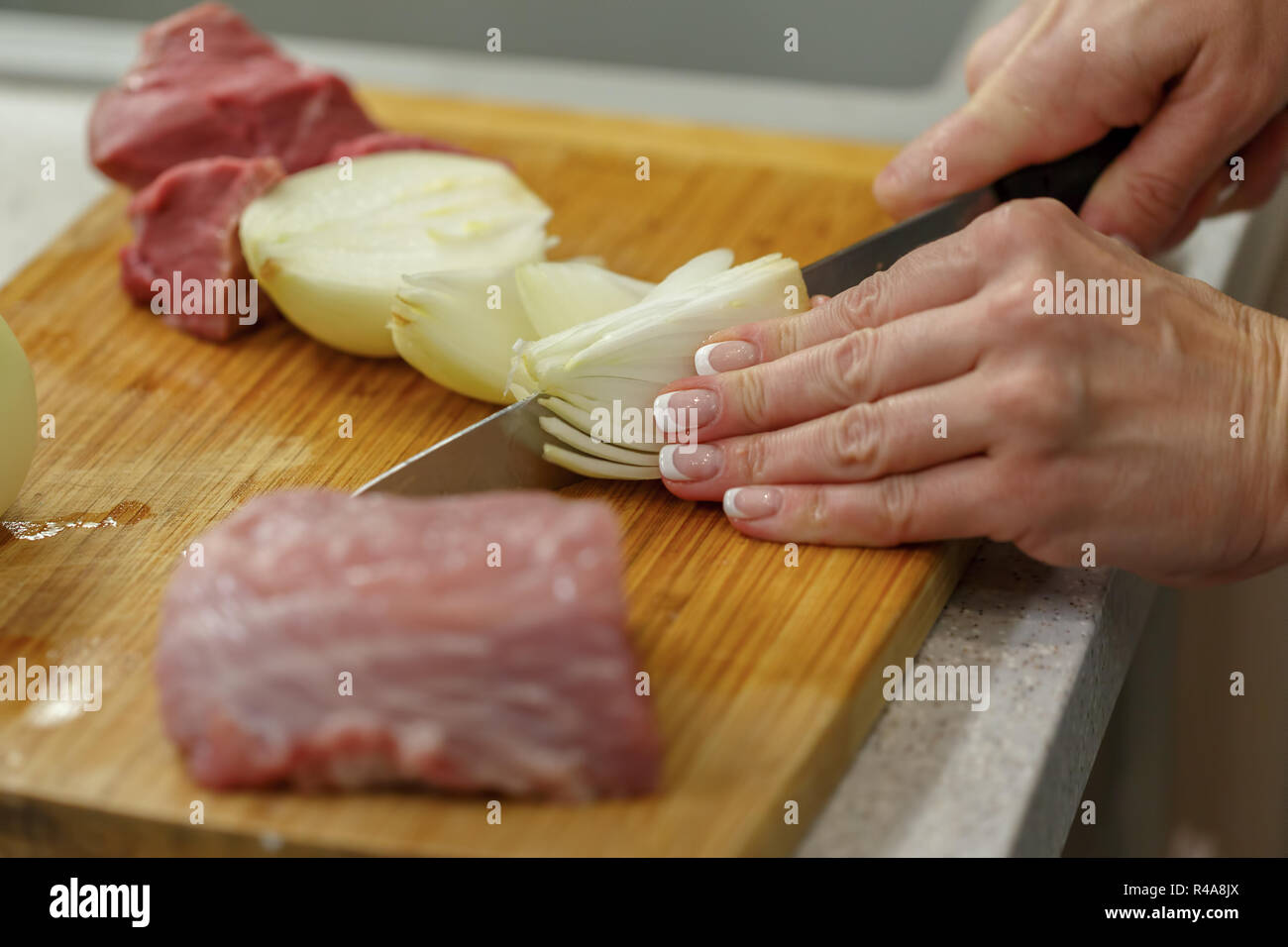 Woman cuts onion on background hi-res stock photography and images - Alamy