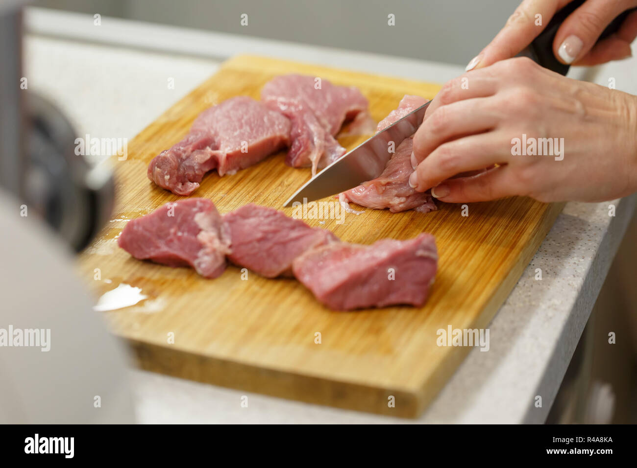 Woman cuts meat pieces hi-res stock photography and images - Alamy