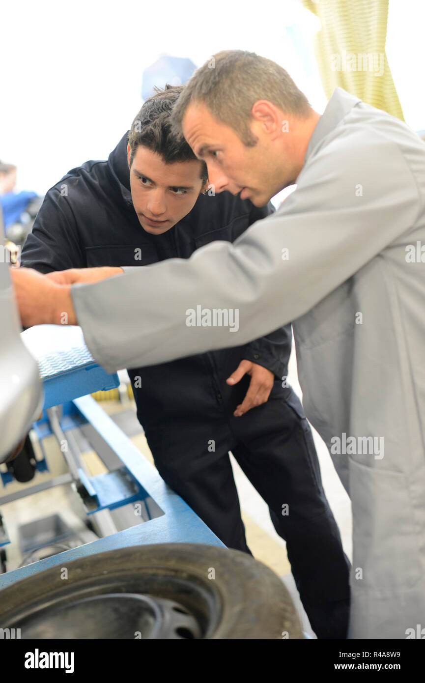 Teacher and student in auto mechanics training class Stock Photo - Alamy