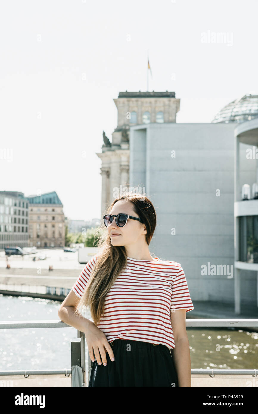 Portrait of a young beautiful girl on the street of Berlin. Lifestyle ...