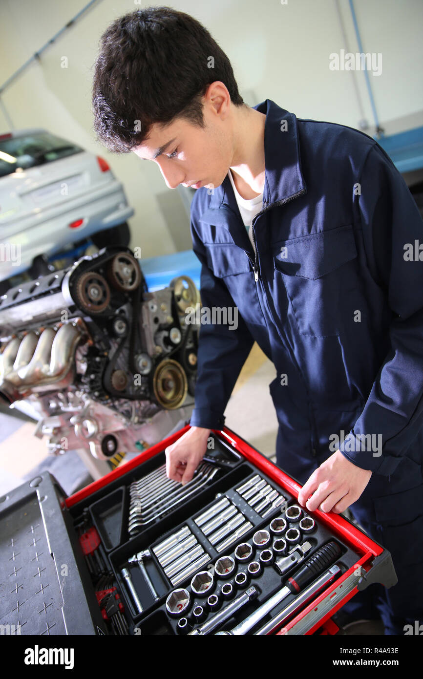 Student in mechanics working on car engine Stock Photo - Alamy