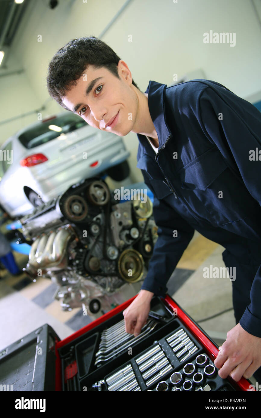Student in mechanics working on car engine Stock Photo - Alamy
