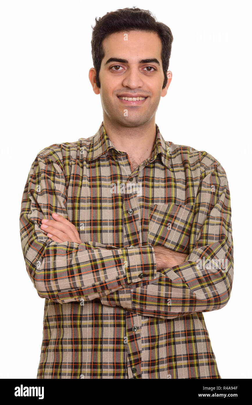 Young happy Persian man smiling with arms crossed Stock Photo - Alamy