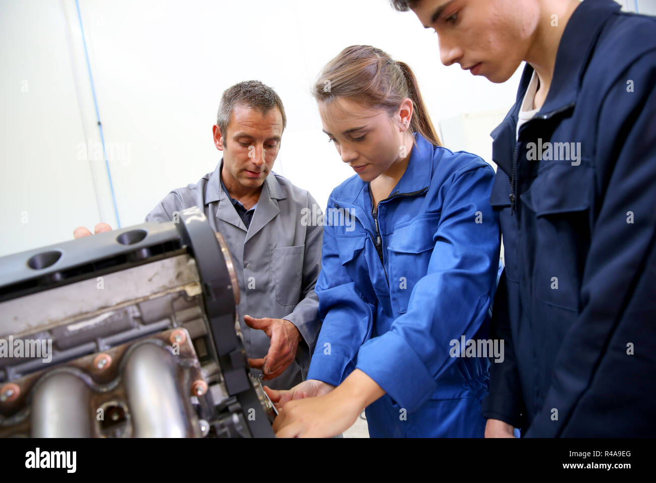 Students with instructor working on auto engine Stock Photo - Alamy