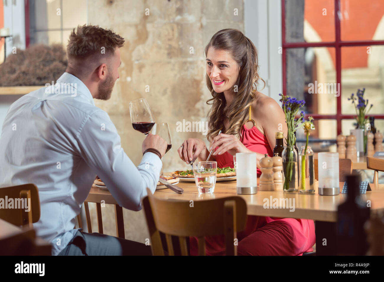 Couple eating food at restaurant Stock Photo - Alamy