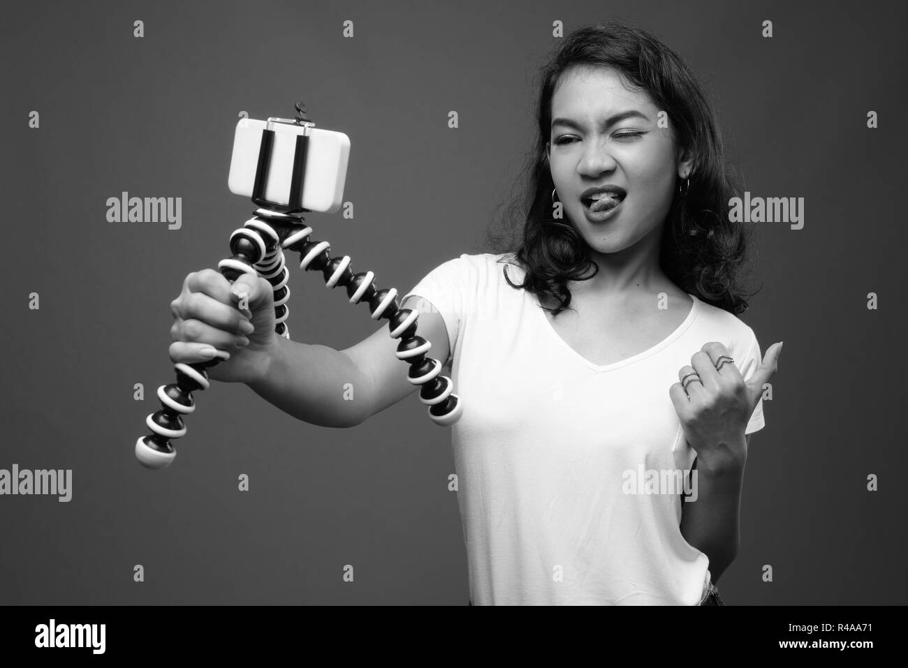 Young beautiful Asian woman vlogging and using mobile phone Stock Photo ...